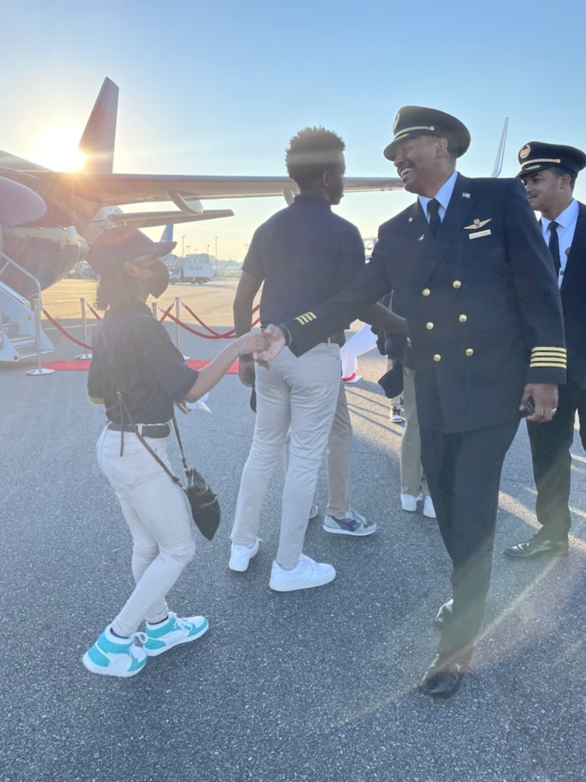 Delta pilot greets a student participating in the 2022 Dream Flight ...